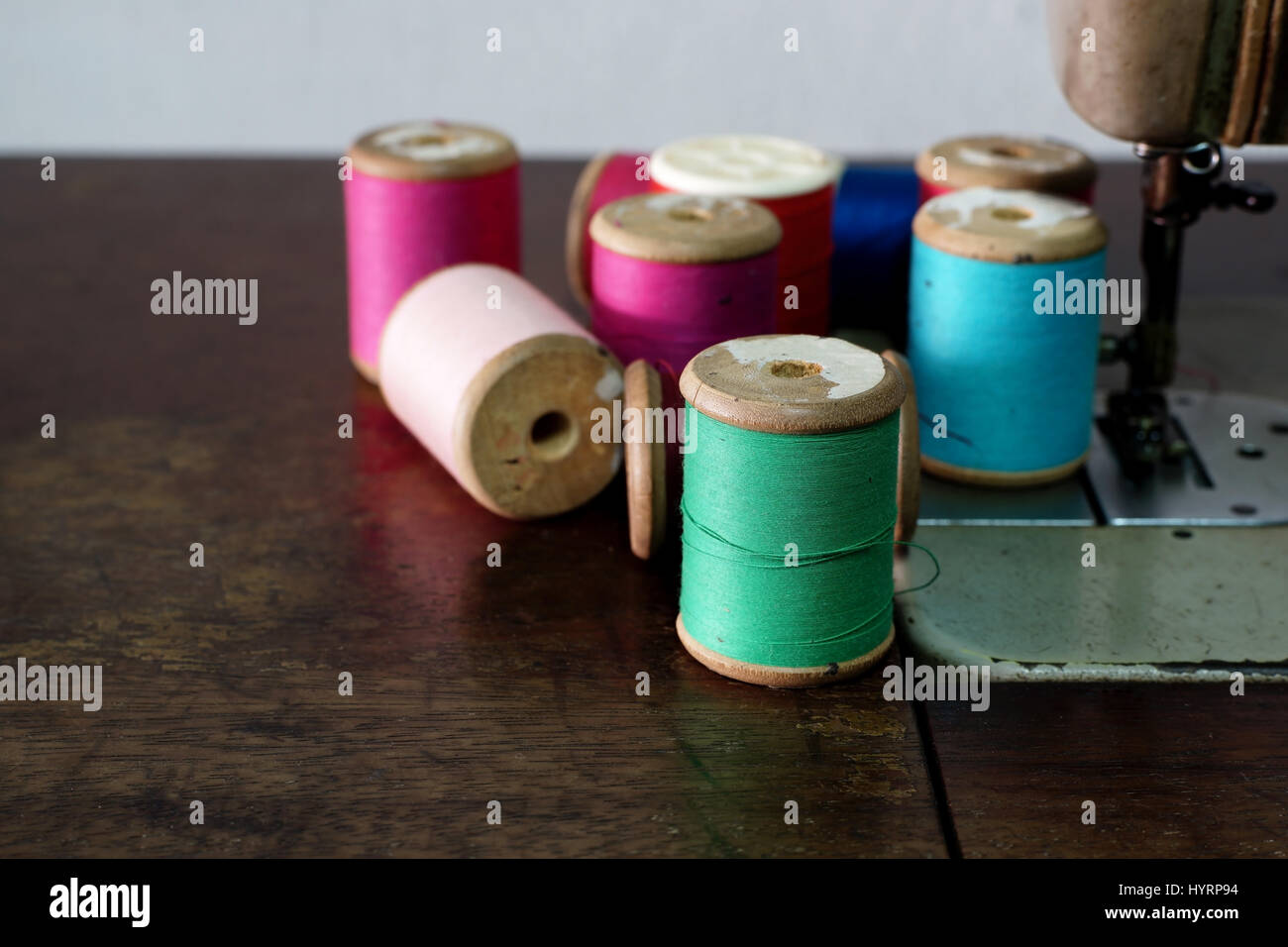 colorful bobbins of thread on sewing machine Stock Photo - Alamy