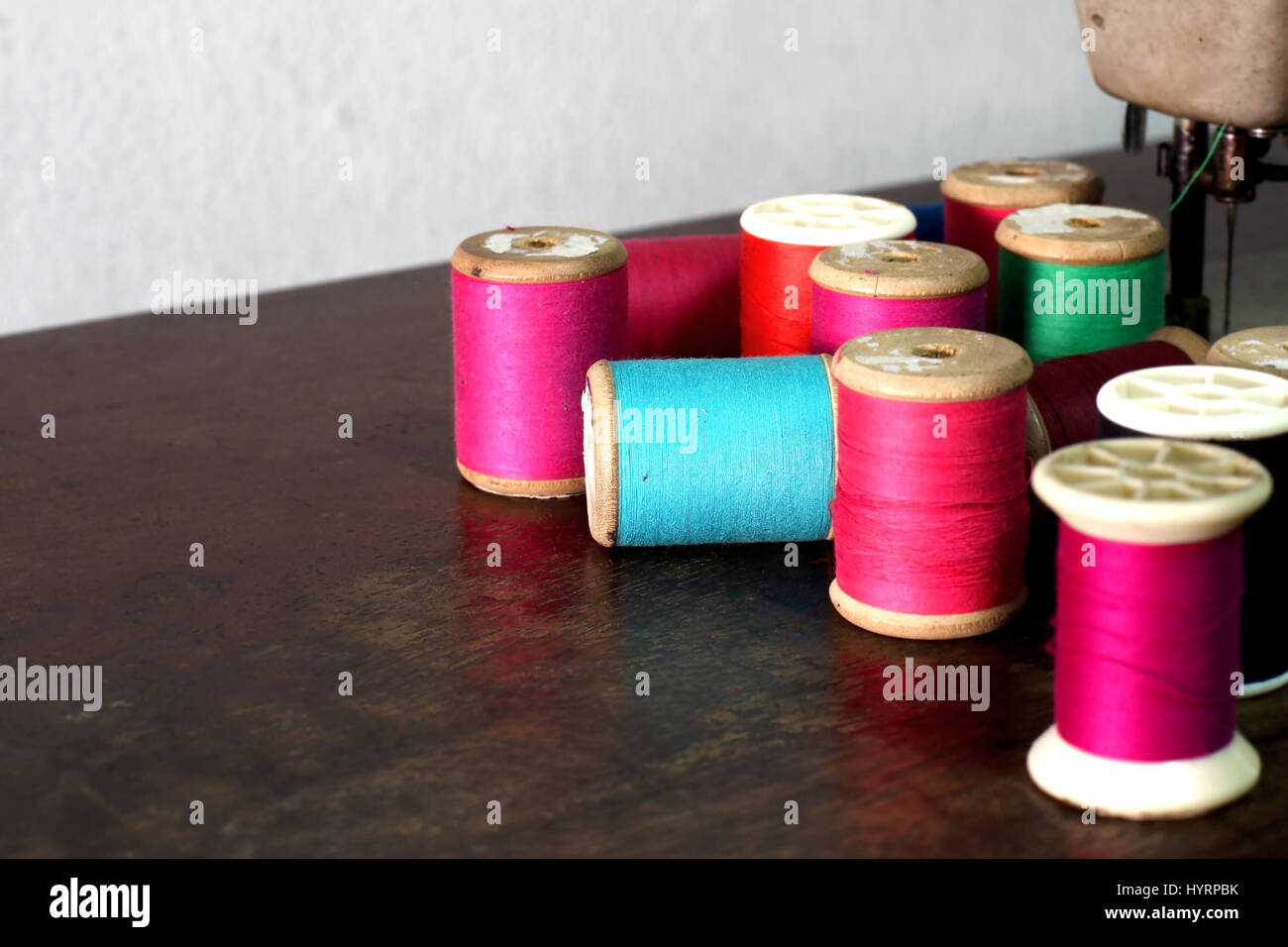 colorful bobbins of thread on sewing machine Stock Photo - Alamy