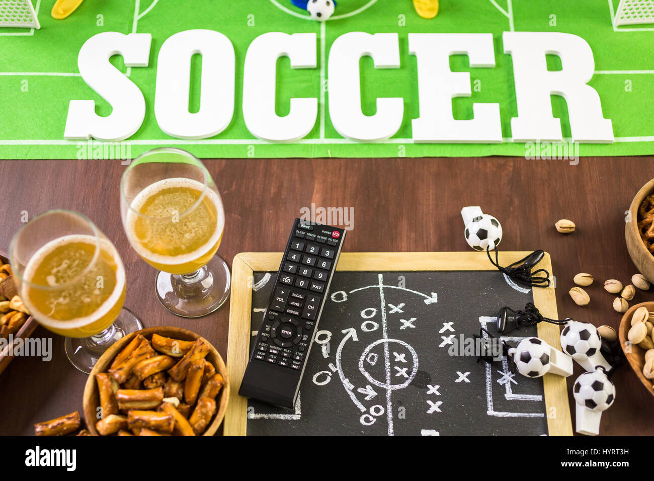 Salty snacks and drinks on the table for soccer party Stock Photo - Alamy