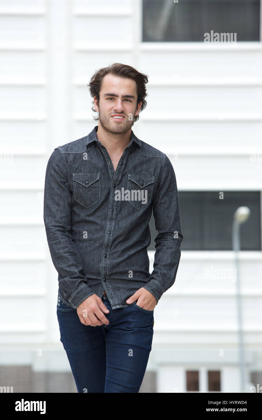 Portrait of a confident young man walking outdoors Stock Photo - Alamy