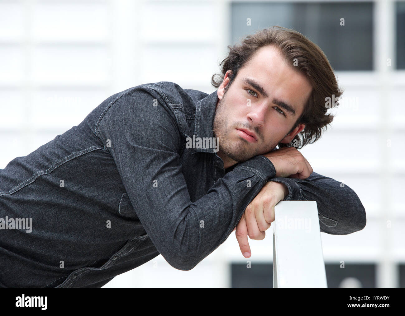 Portrait of a young man resting outside Stock Photo - Alamy