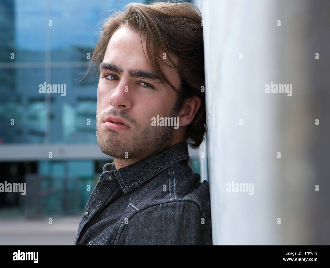 Close up portrait of a cool man posing outdoors Stock Photo - Alamy