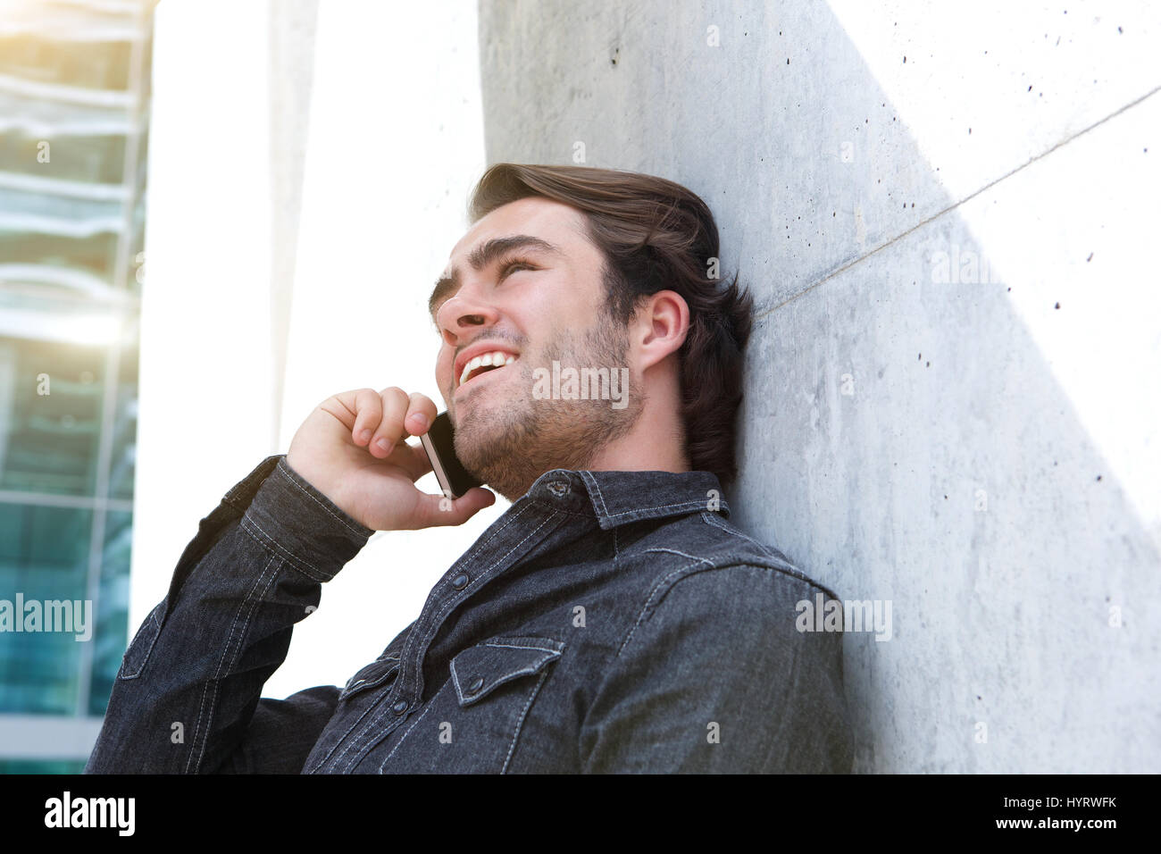 Portrait of a cool young man calling by mobile phone outside Stock ...
