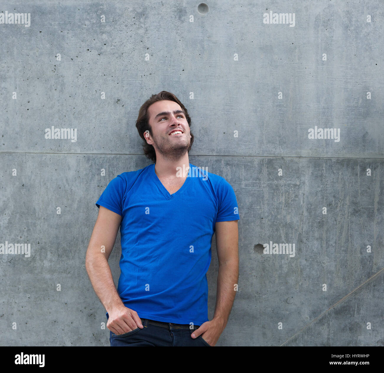 Portrait of a cool guy in blue shirt smiling outside Stock Photo - Alamy