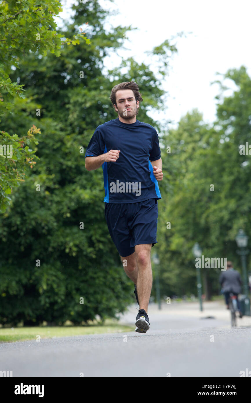 Full body of a young man jogging outdoors Stock Photo - Alamy