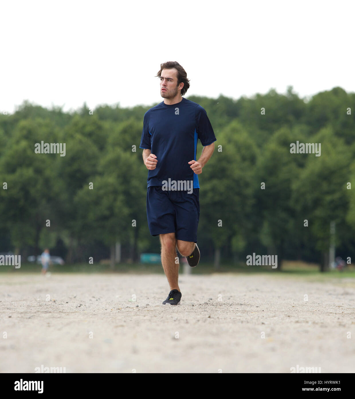 Healthy young man jogging outdoors in park Stock Photo - Alamy