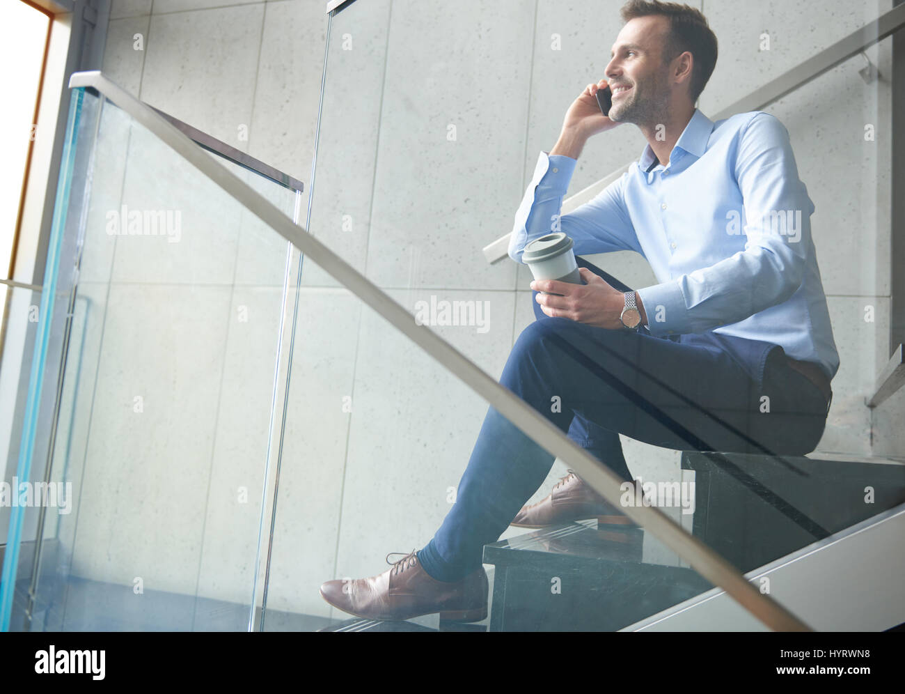 Businessman having break on the steps Stock Photo - Alamy