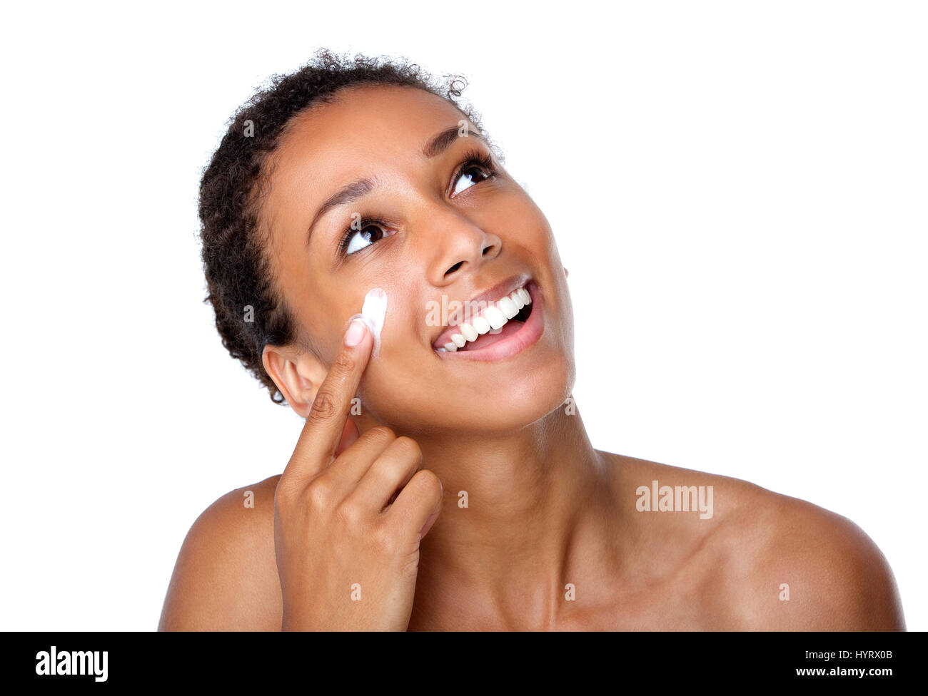 Close up portrait of a smiling woman applying lotion on face Stock ...
