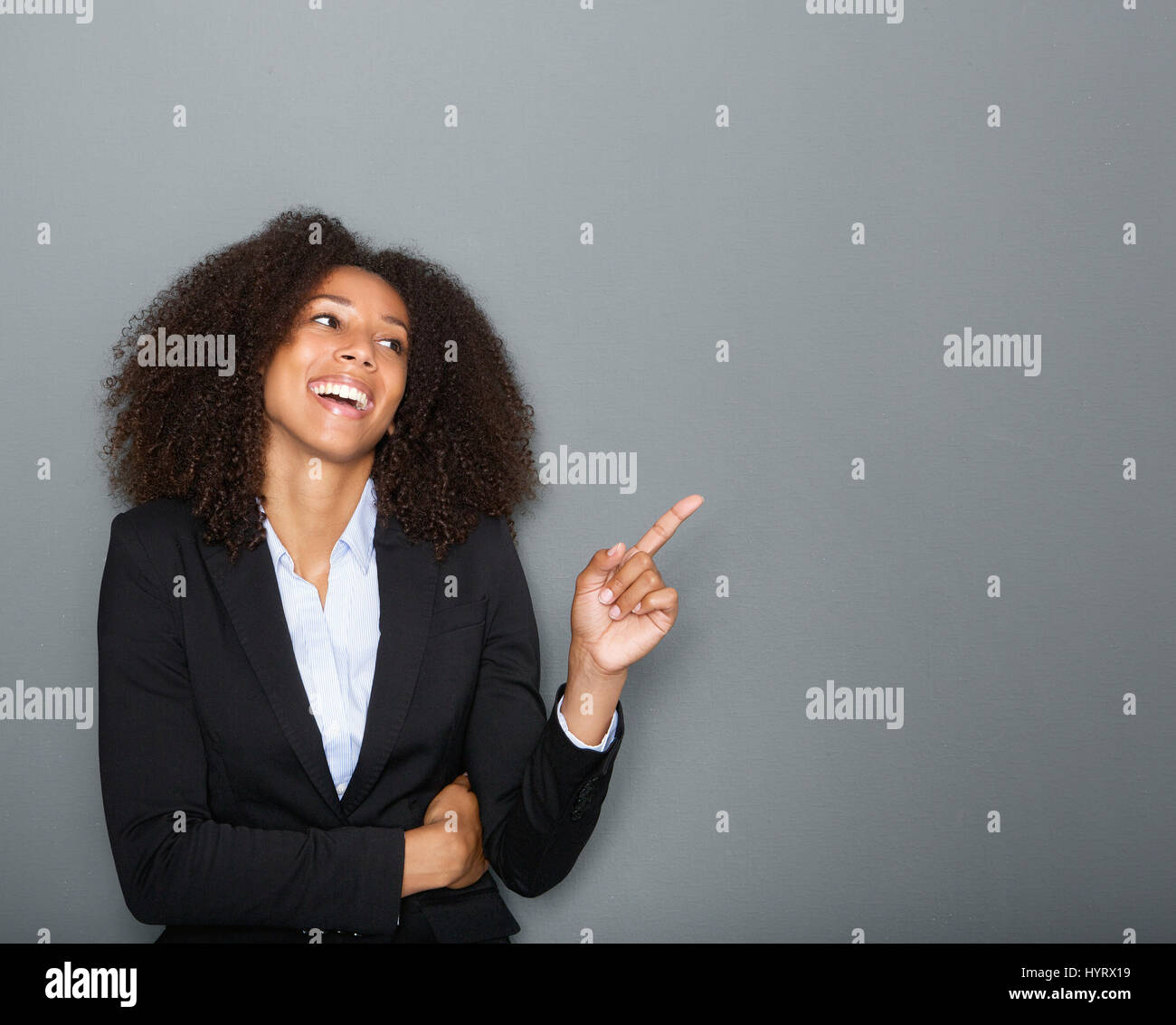 Portrait of a young african american business woman pointing finger ...
