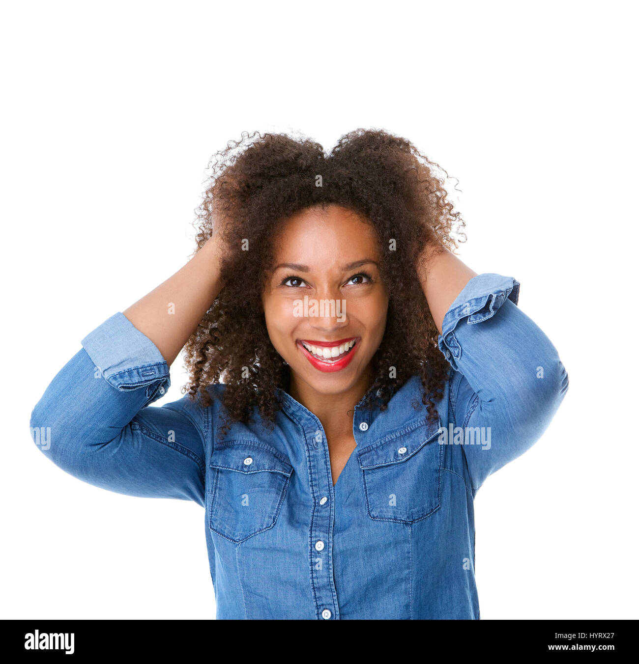 Close up portrait of a beautiful young woman smiling with hand in hair ...