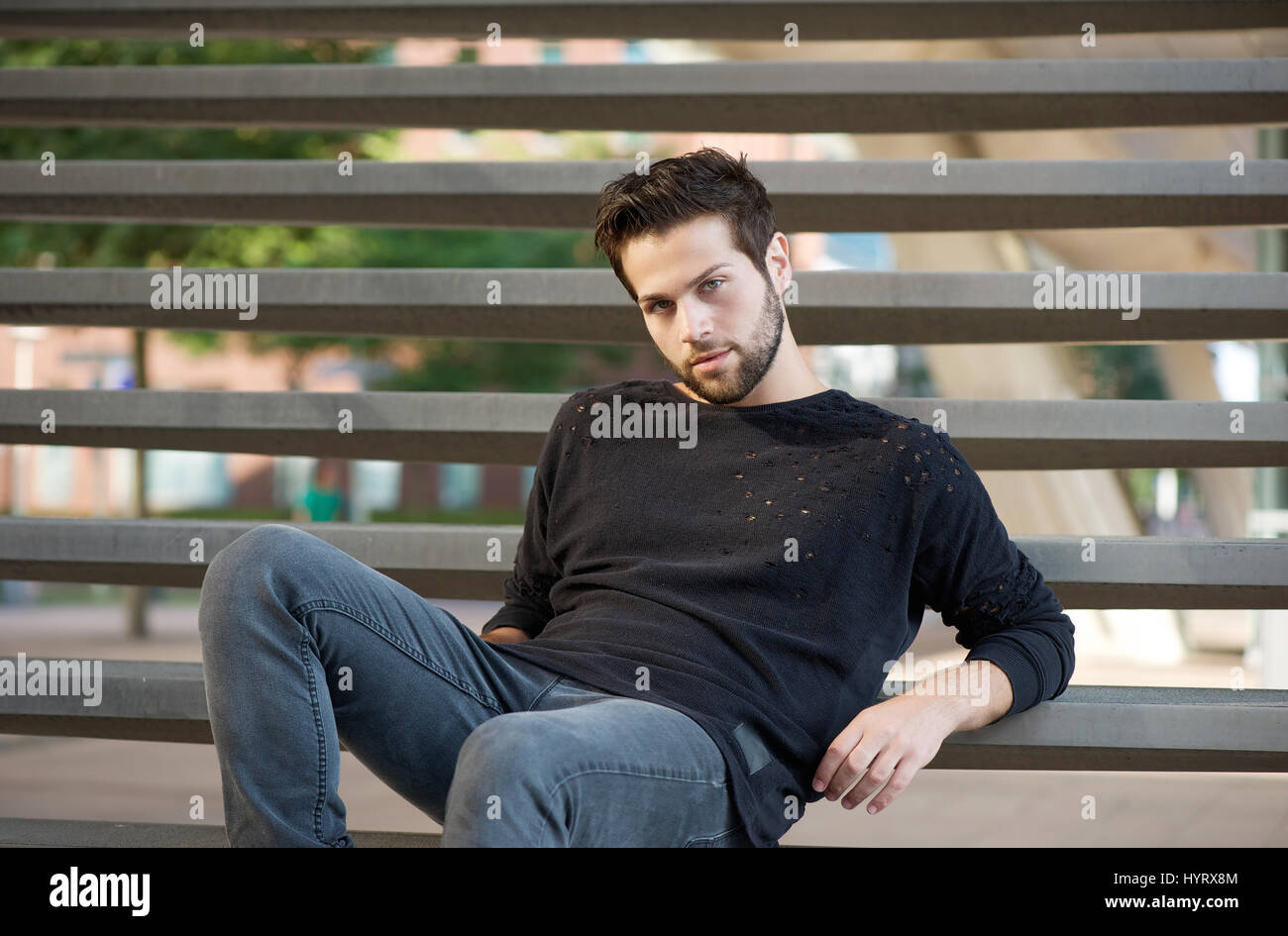 Portrait of a cool guy sitting on steps outdoors Stock Photo - Alamy