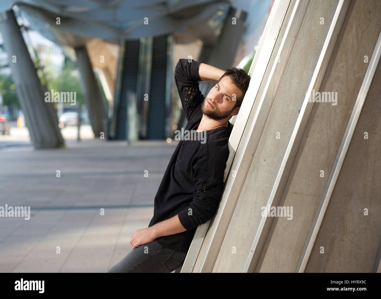 Portrait of a funky male fashion model standing outdoors Stock Photo ...