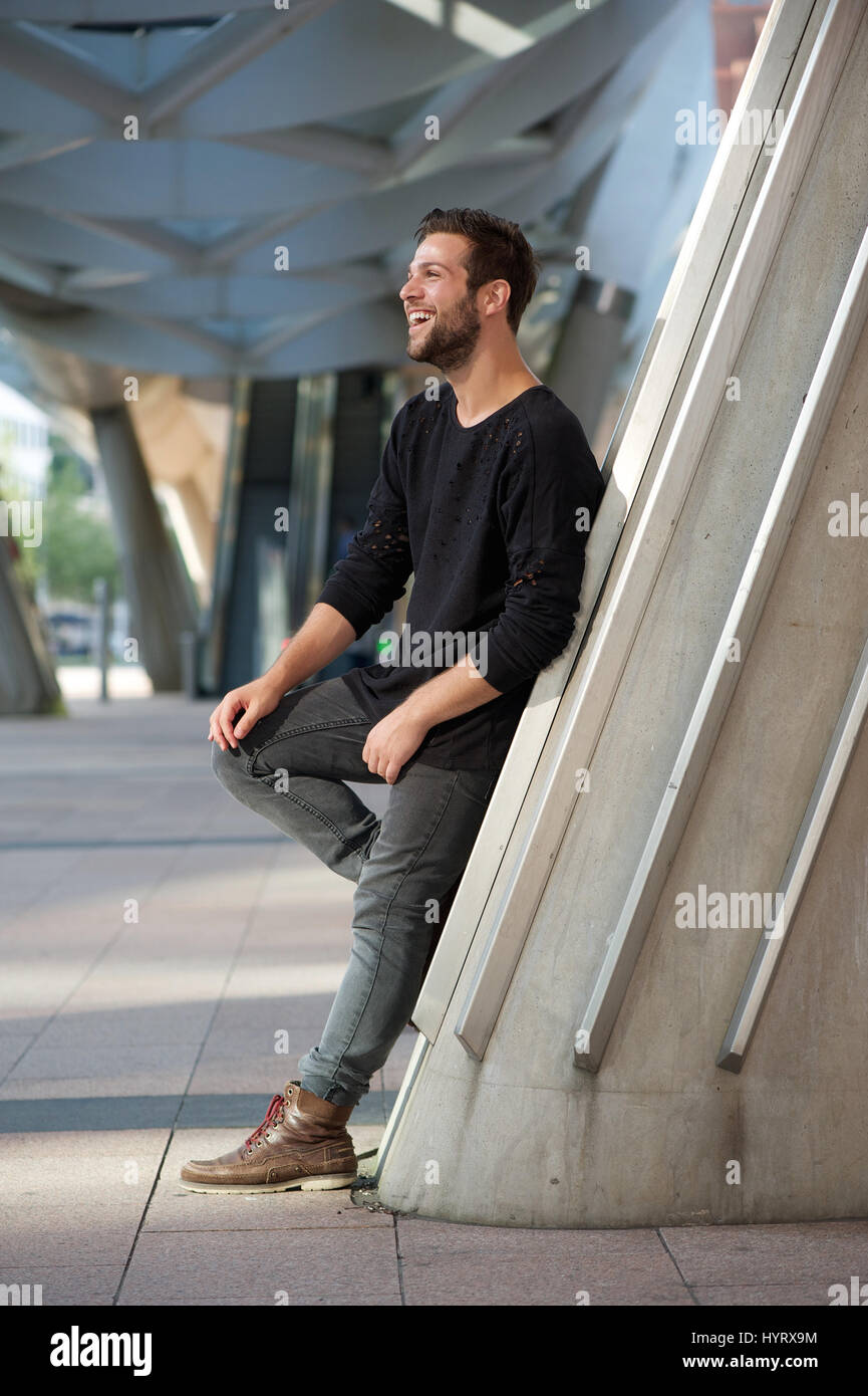 Full length side view portrait of smiling man standing outdoors Stock ...