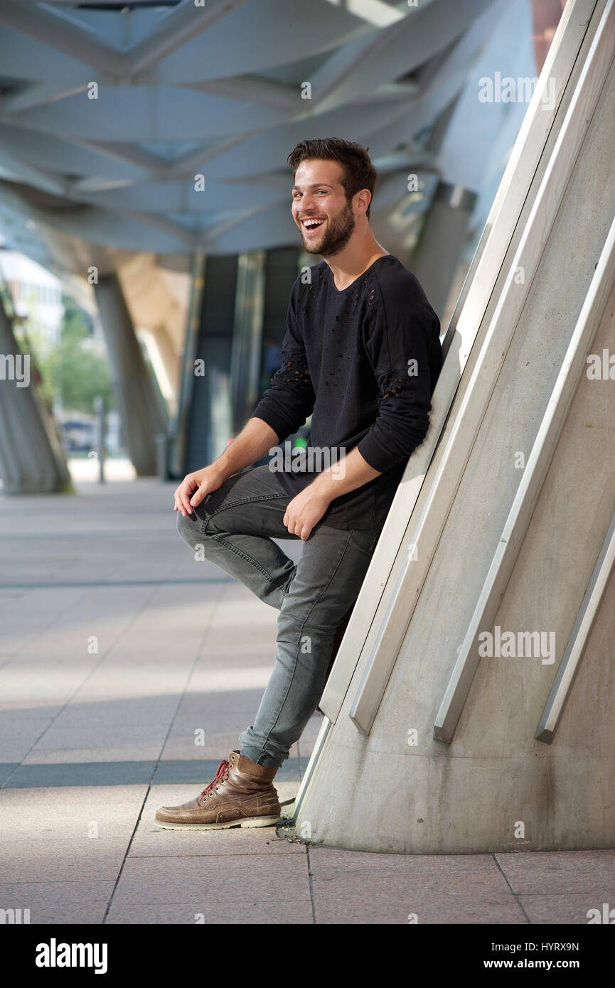 Side view full length portrait of a happy man relaxing outdoors Stock ...
