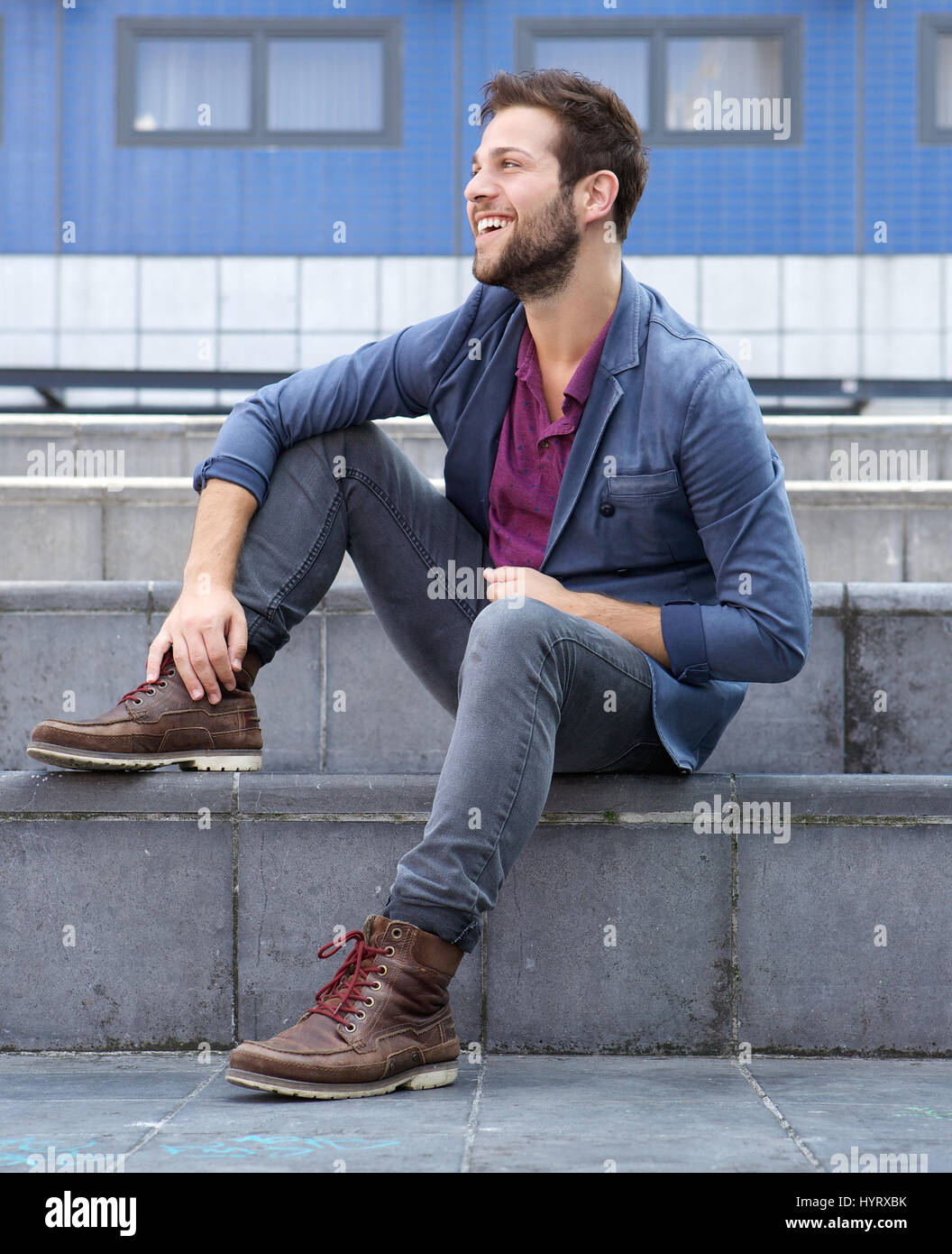 Portrait of a trendy young man smiling outside Stock Photo - Alamy