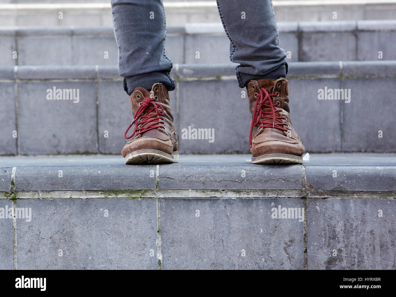 Close up male leather boots on steps Stock Photo - Alamy