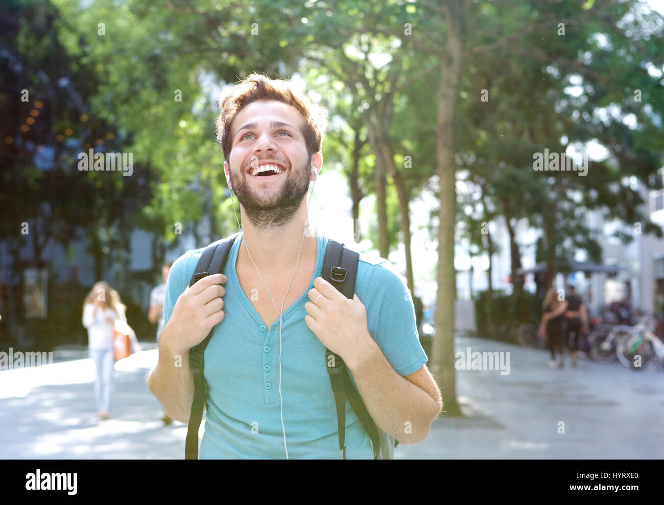 Close up portrait of a handsome young man walking outdoors with ...