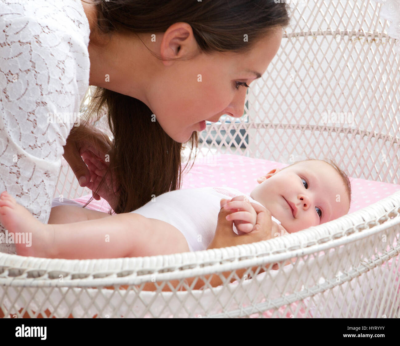Close up portrait of an attractive woman with baby in cot Stock Photo ...