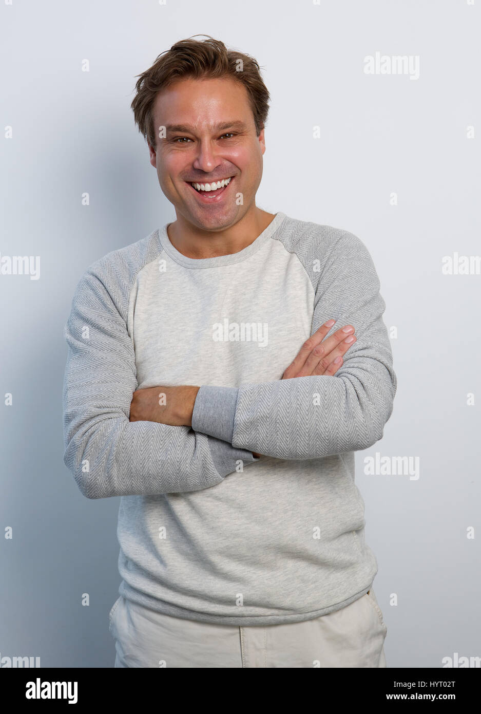 Portrait of a happy man smiling with arms crossed Stock Photo - Alamy