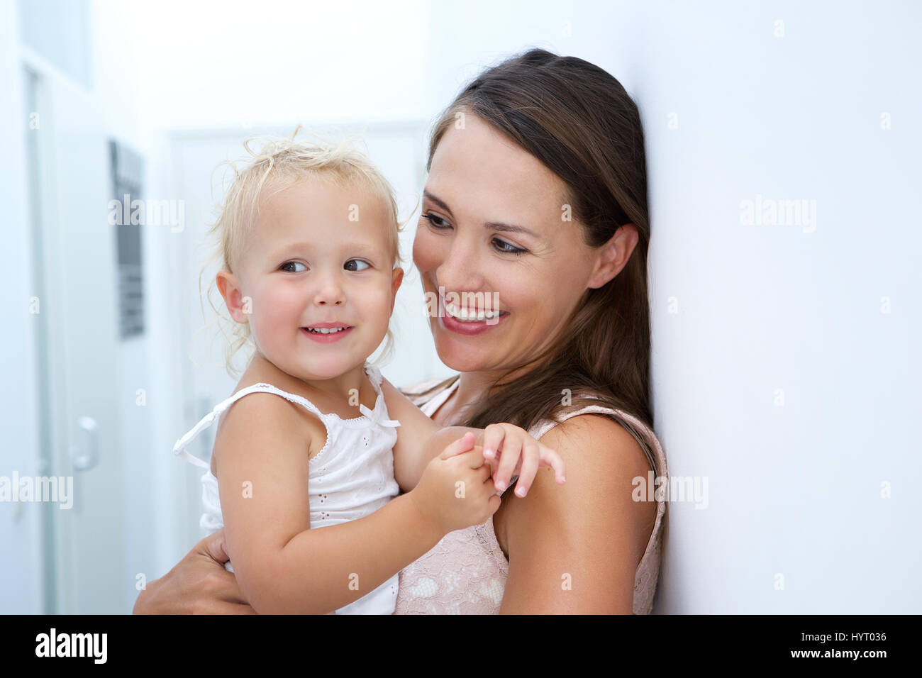 Close up portrait of mother and baby daughter smiling indoors Stock ...