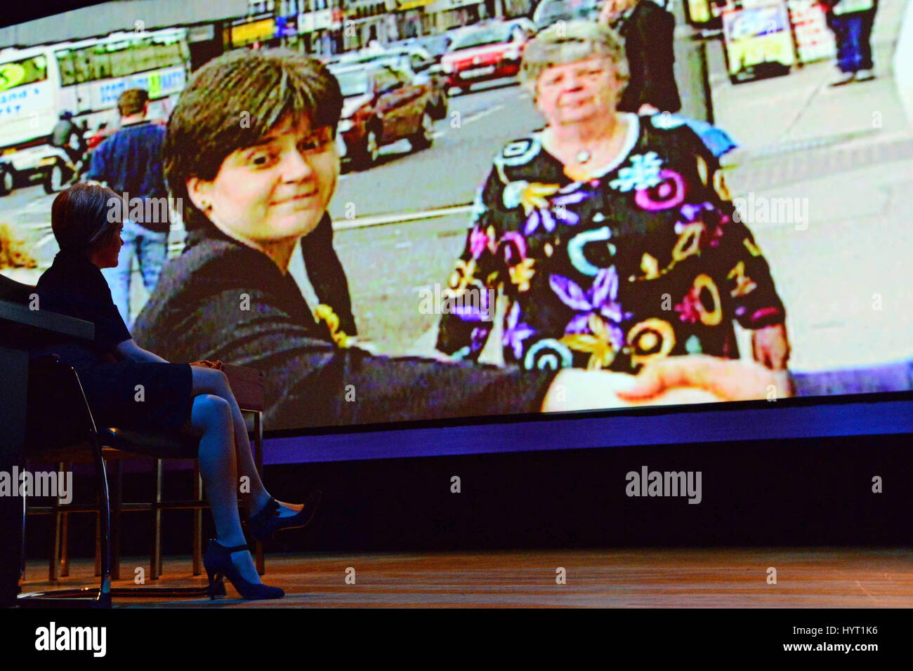 A young onscreen Nicola Sturgeon seems to look back at herself onstage ...