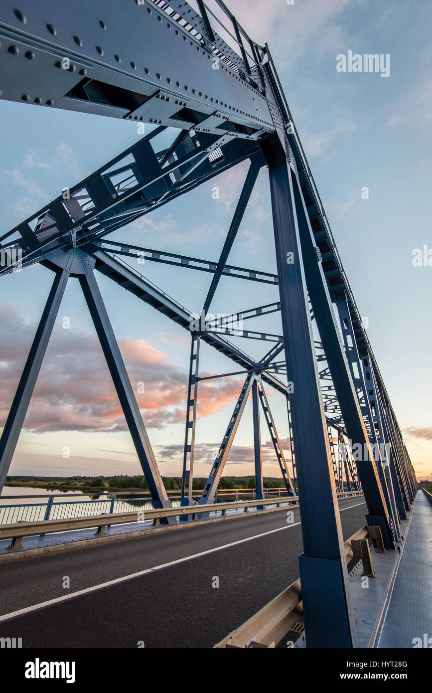railway bridge with metal rails near river in sunset Stock Photo - Alamy