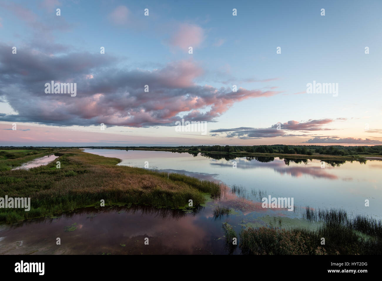 Beautiful summer sunset at the river with blue sky, red and orange ...