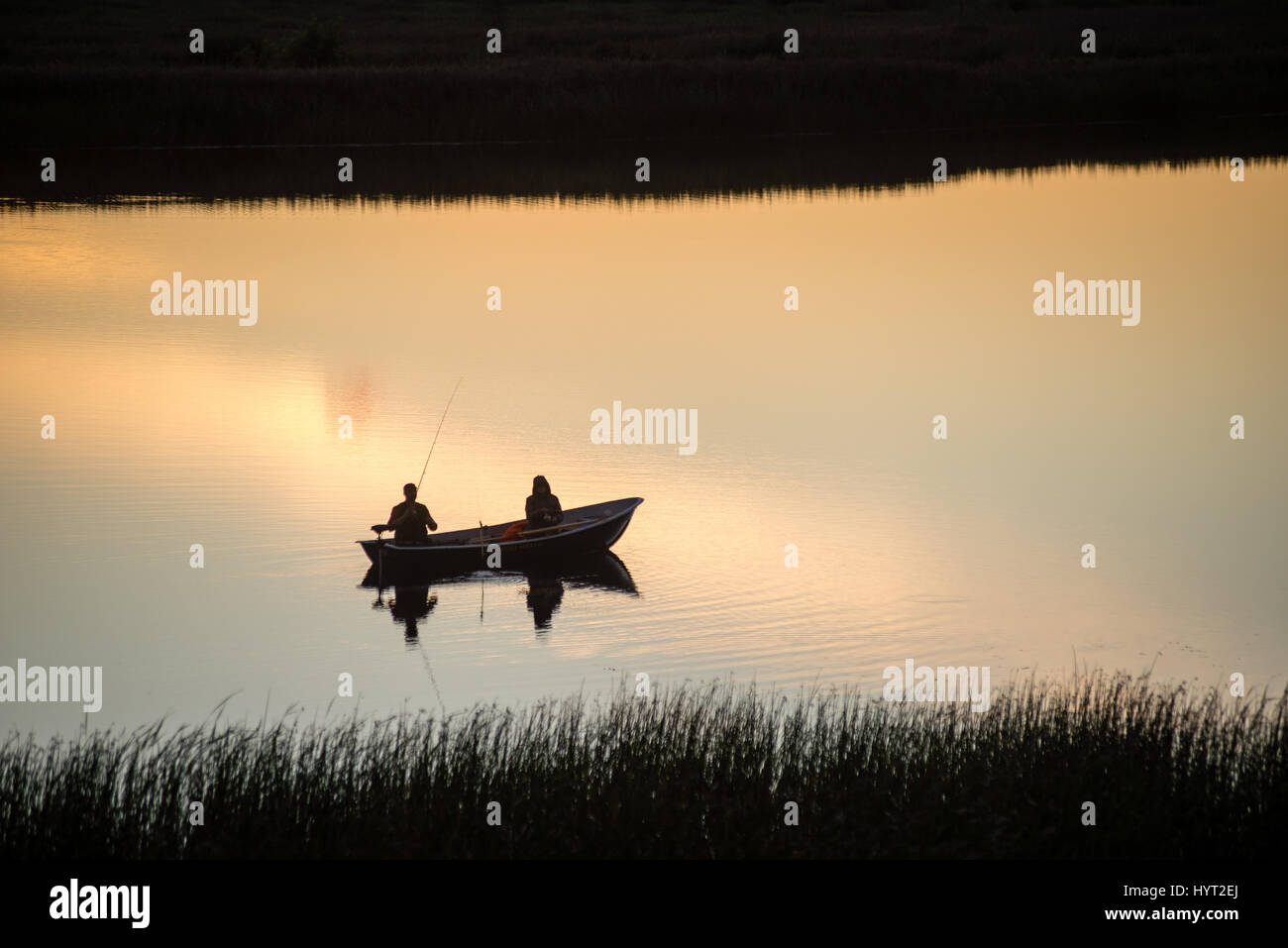 colorful orange sunrise over the lake in summer with small boat Stock ...