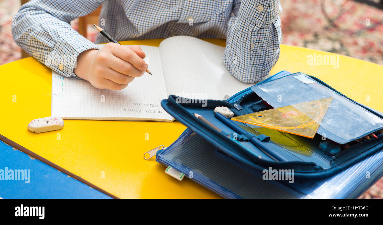Children on the writting lesson at school with their school supplies ...