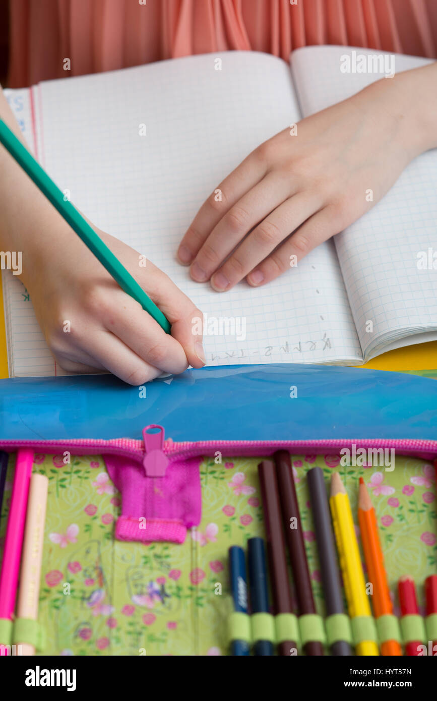 Children on the writting lesson at school with their school supplies ...