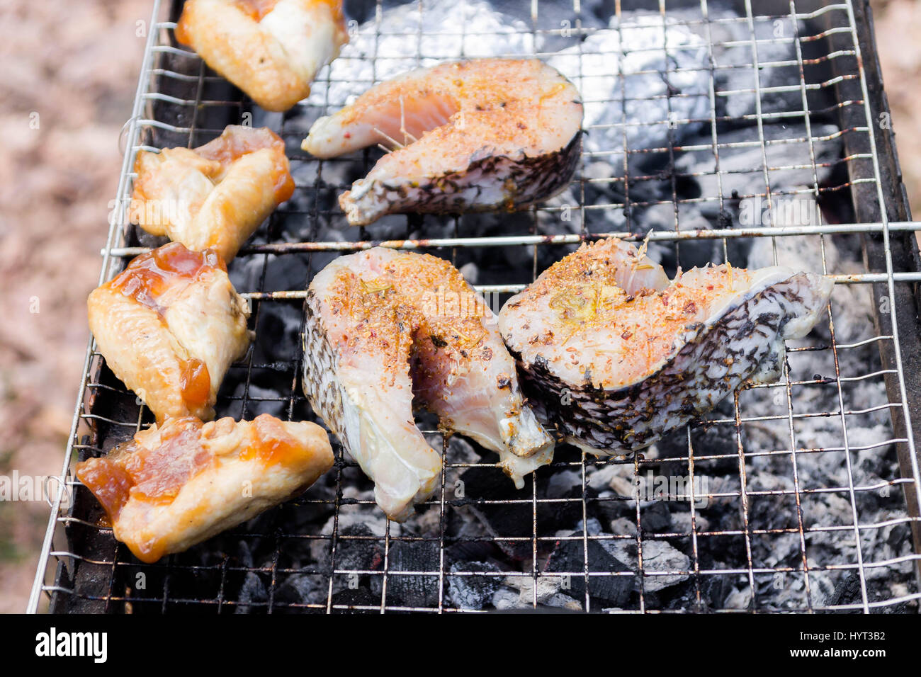Cooking on the grill, barbecue. Fish steaks and chicken wings Stock ...