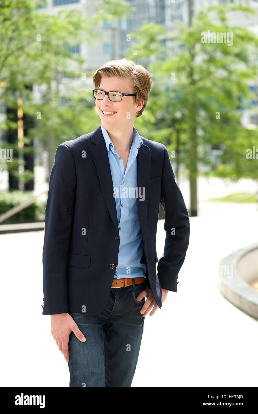 Portrait of a casual young businessman smiling outdoors Stock Photo - Alamy