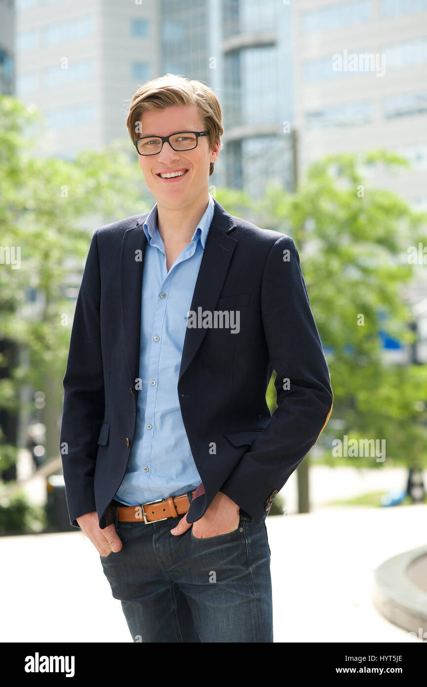 Portrait of a young businessman smiling outdoors Stock Photo - Alamy