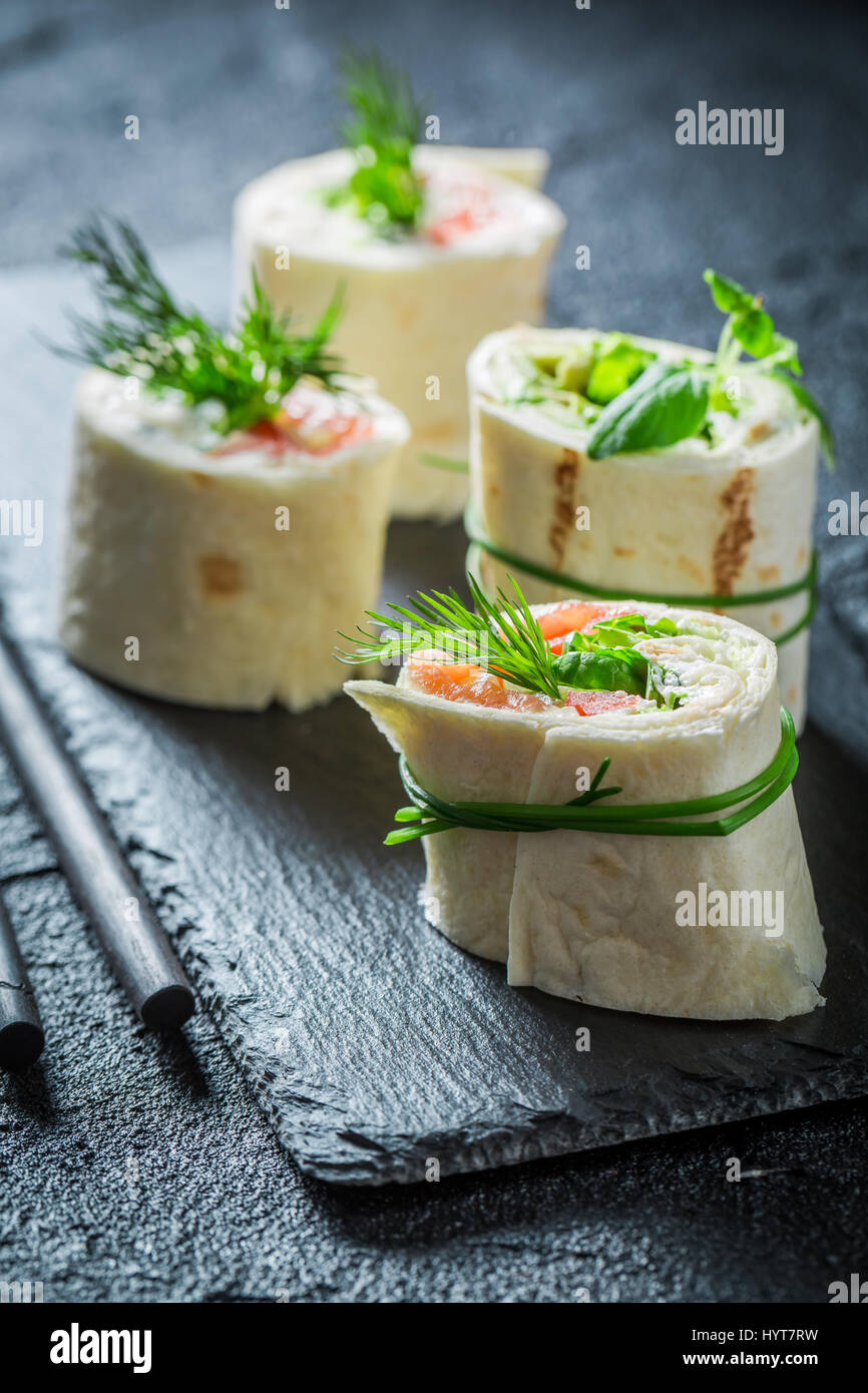 Tasty rolls with salmon, cheese and vegetables for a snack Stock Photo ...