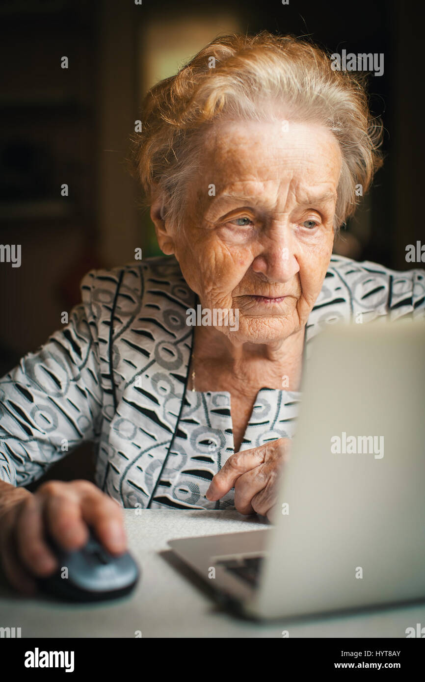 Retired woman working on computer at home Stock Photo - Alamy