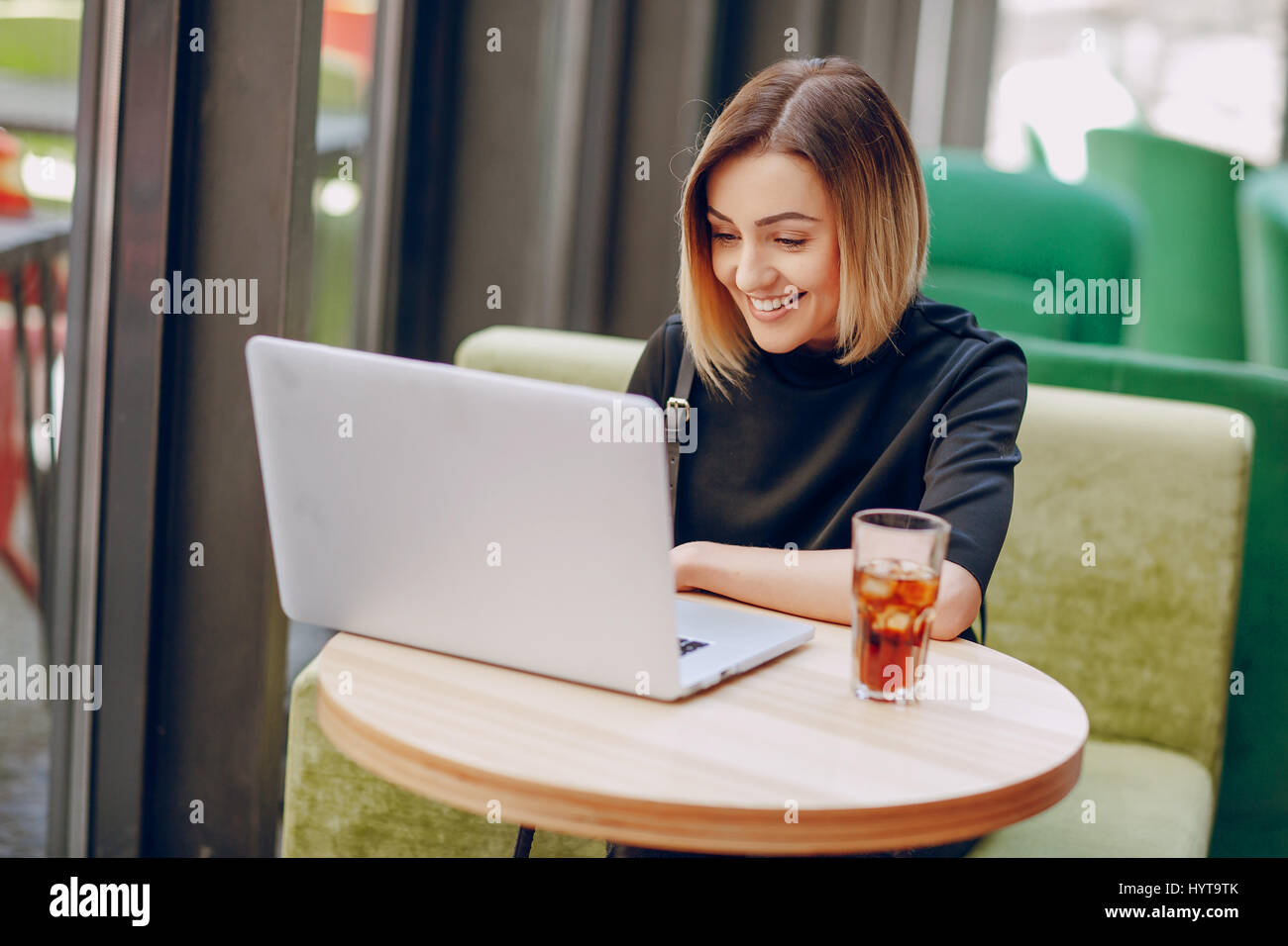 girl laptop cafe cocktail Stock Photo - Alamy