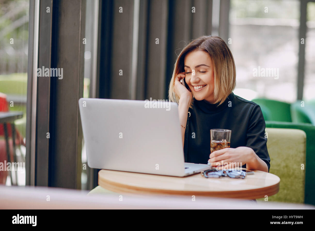 girl laptop cafe cocktail Stock Photo - Alamy