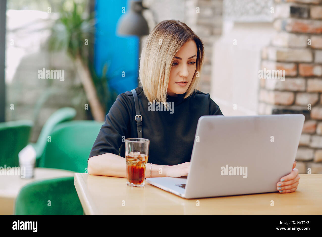 girl laptop cafe cocktail Stock Photo - Alamy