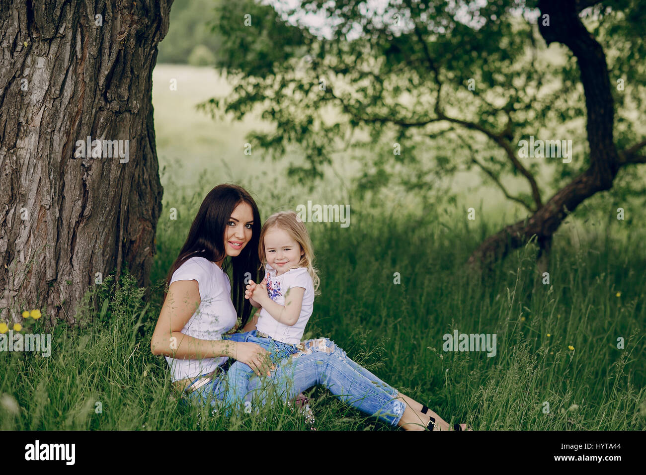 child near tree with mom Stock Photo - Alamy