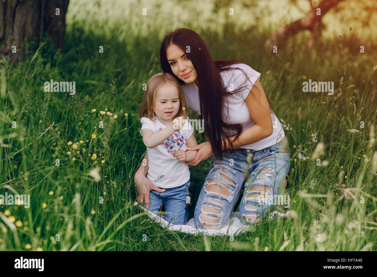 child near tree with mom Stock Photo - Alamy