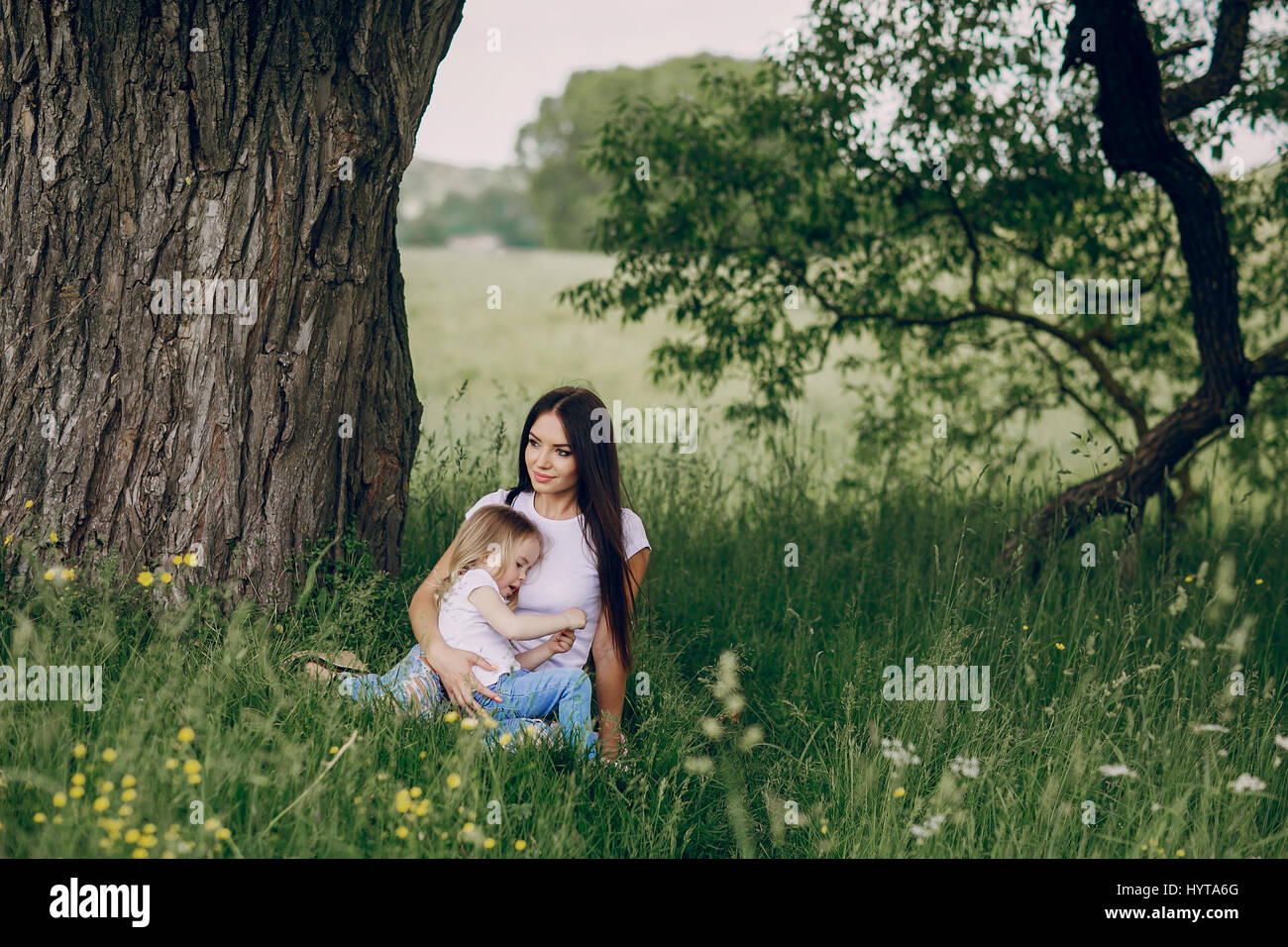 child near tree with mom Stock Photo - Alamy