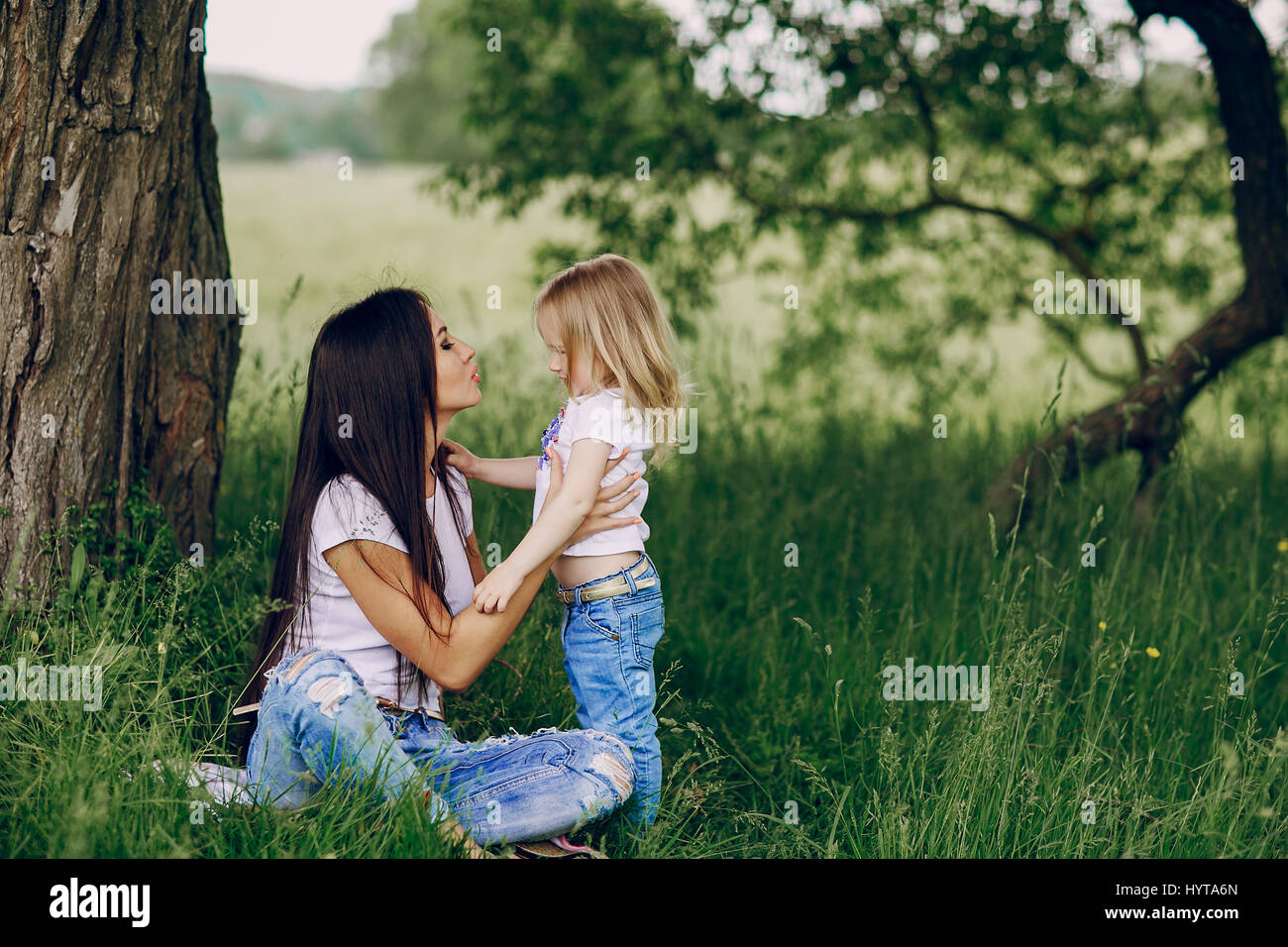 child near tree with mom Stock Photo - Alamy