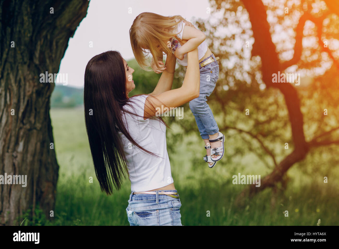 child near tree with mom Stock Photo - Alamy