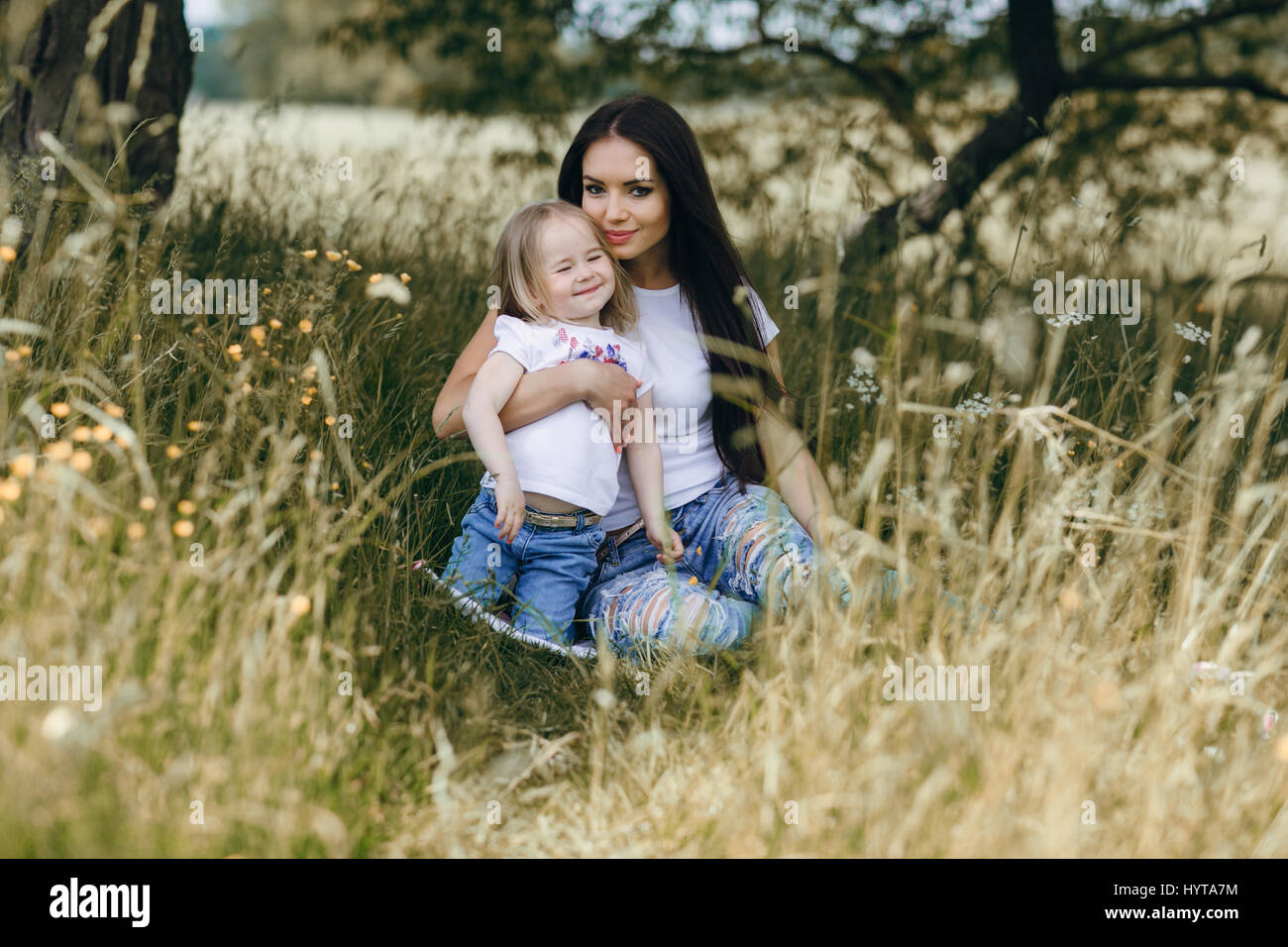 child near tree with mom Stock Photo - Alamy