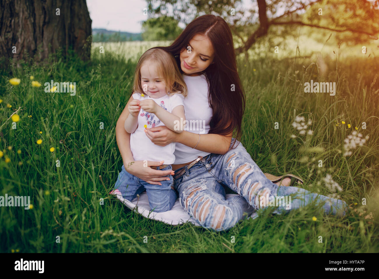 child near tree with mom Stock Photo - Alamy