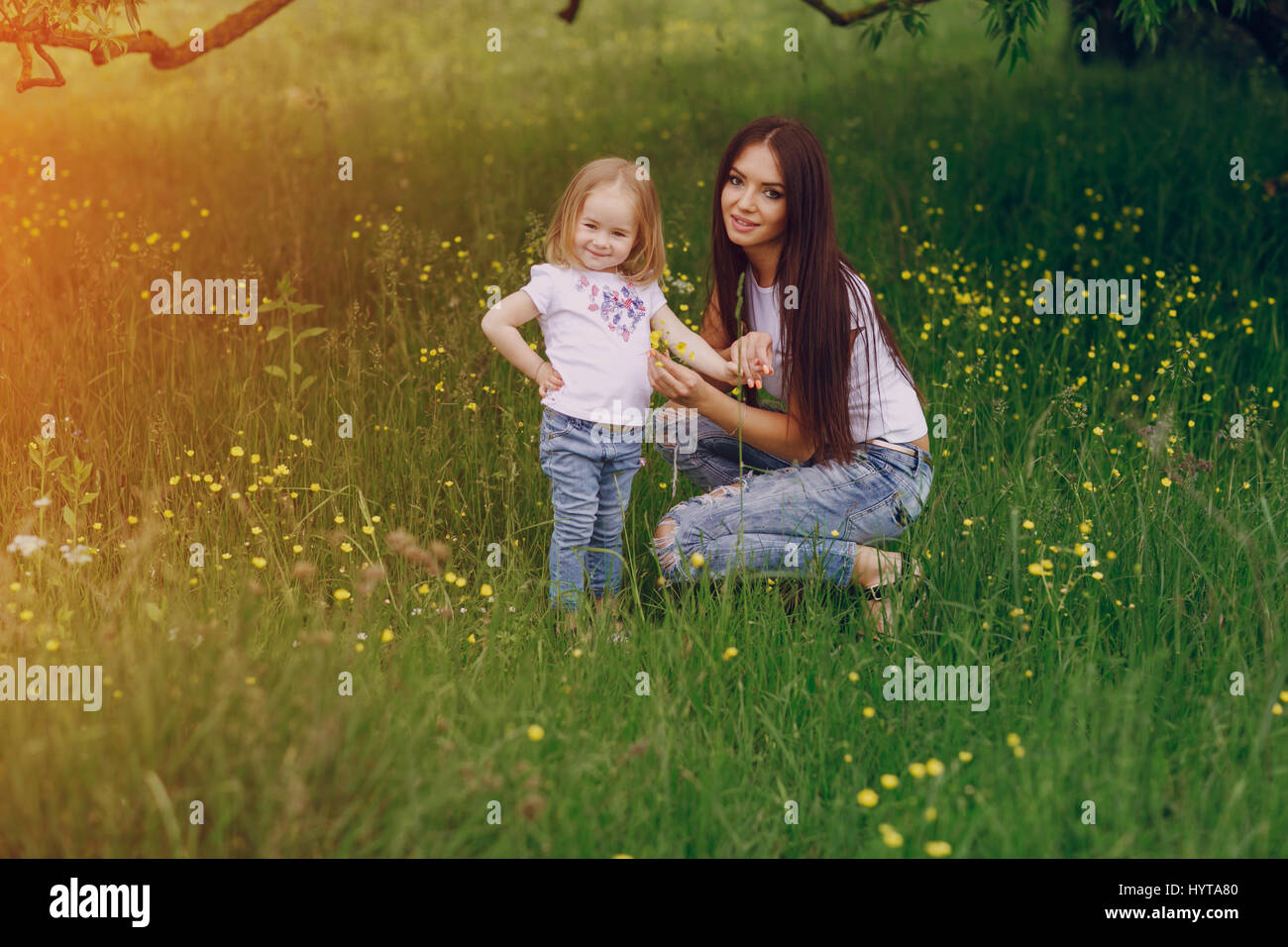 child near tree with mom Stock Photo - Alamy