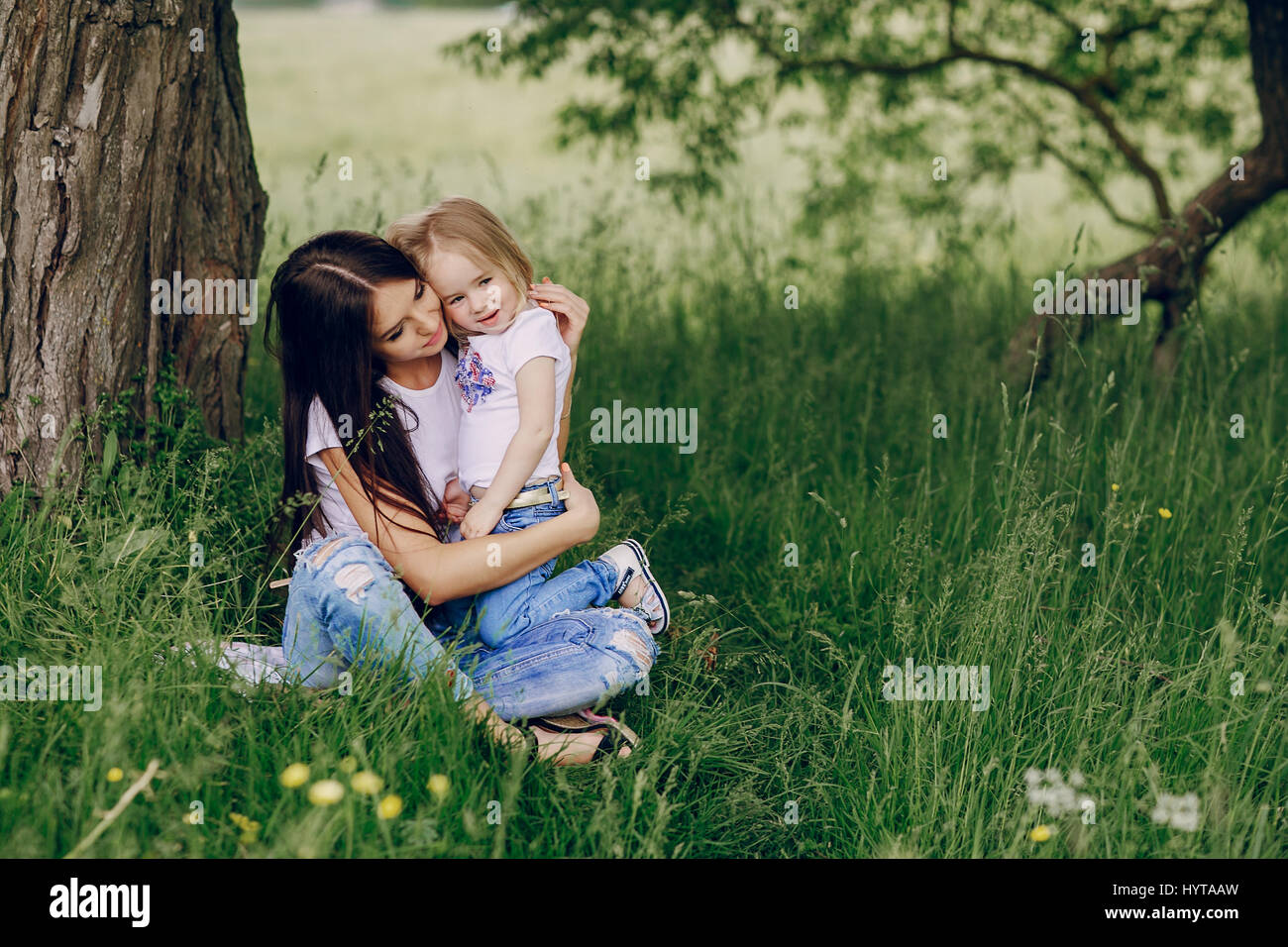 child near tree with mom Stock Photo - Alamy