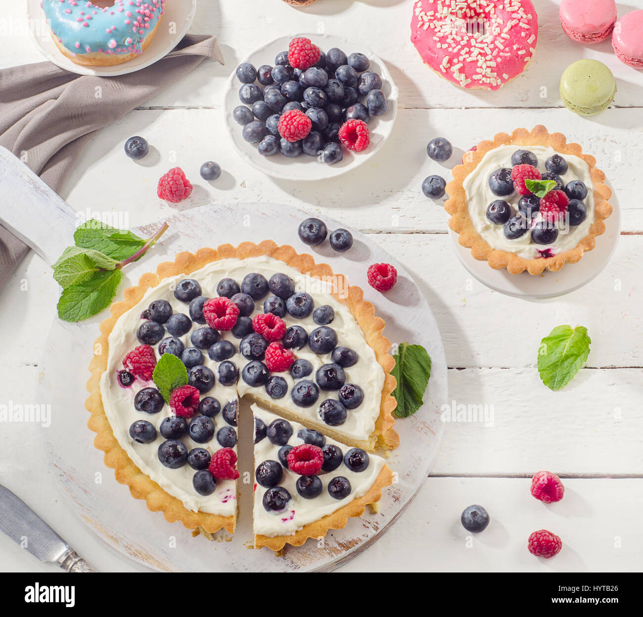 Sweet desserts with blueberries and raspberries. Flat lay Stock Photo ...