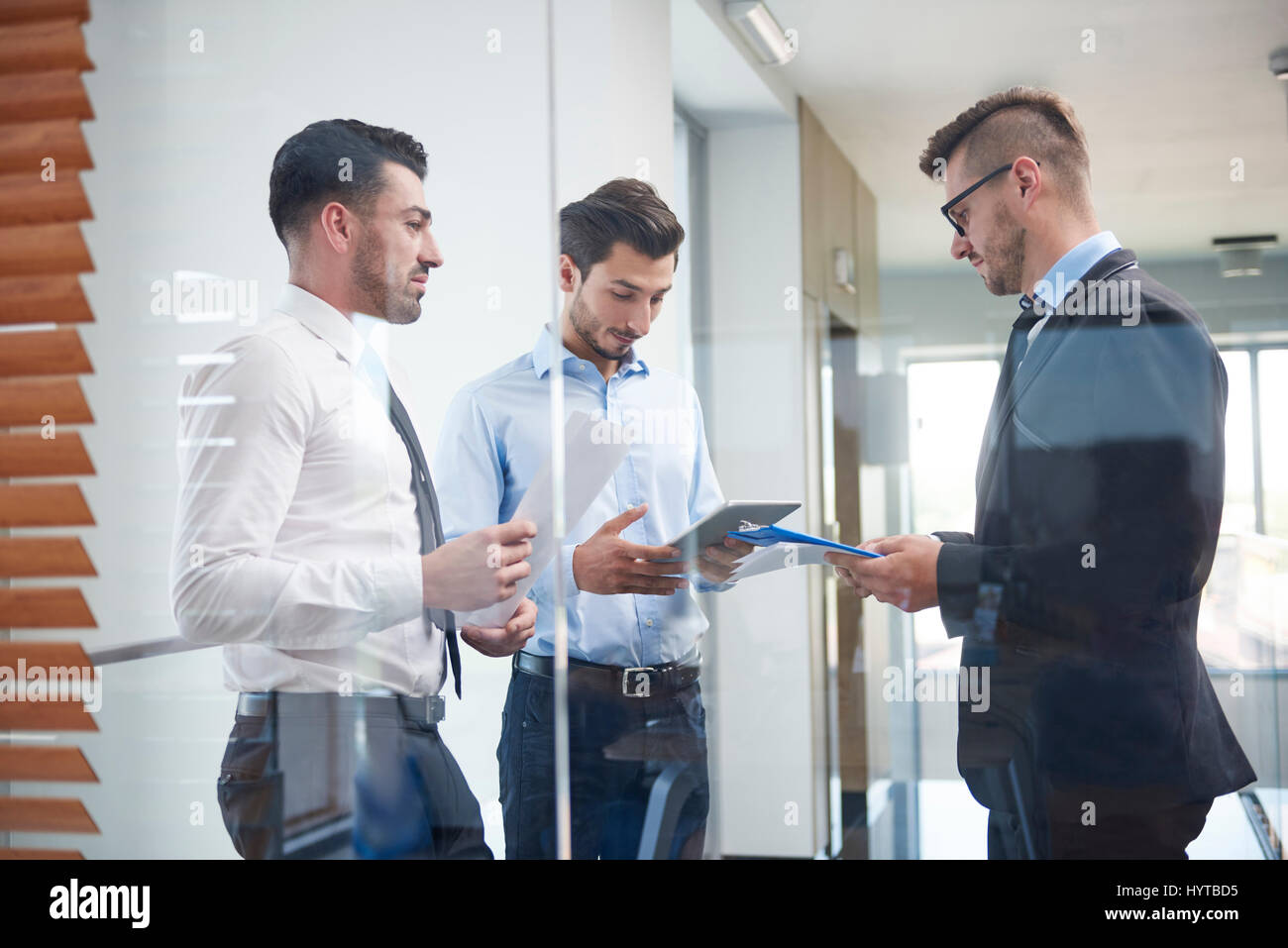 Three businessmen at their office Stock Photo - Alamy