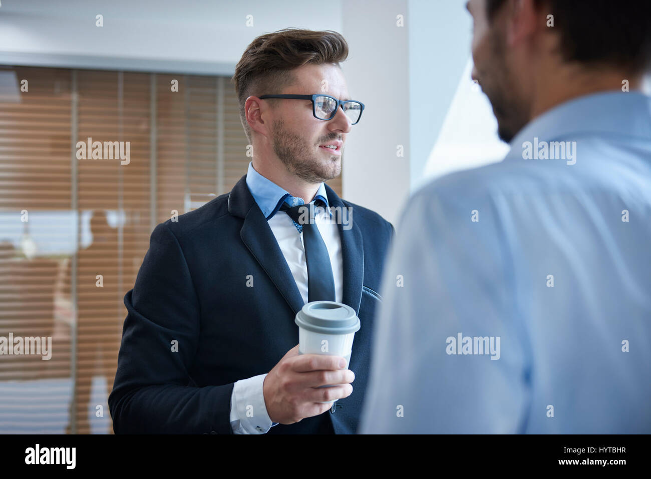 Men talking over a cup of coffee Stock Photo - Alamy